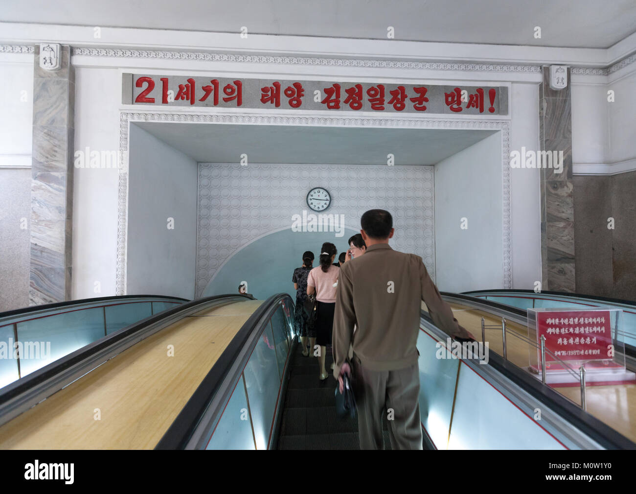 North Korean people using escalator leading to the subway station ...