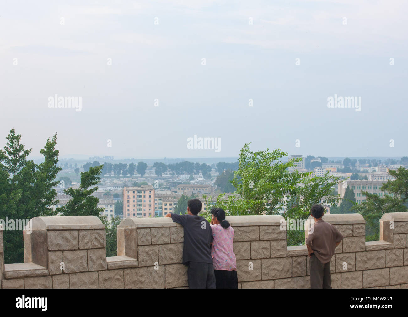 North Korean people looking the city from a hill from the ramparts ...