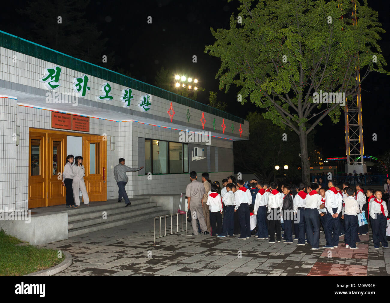 North Korean pioneers queueing to enter the video games center in Kaeson youth parkfun fair ...