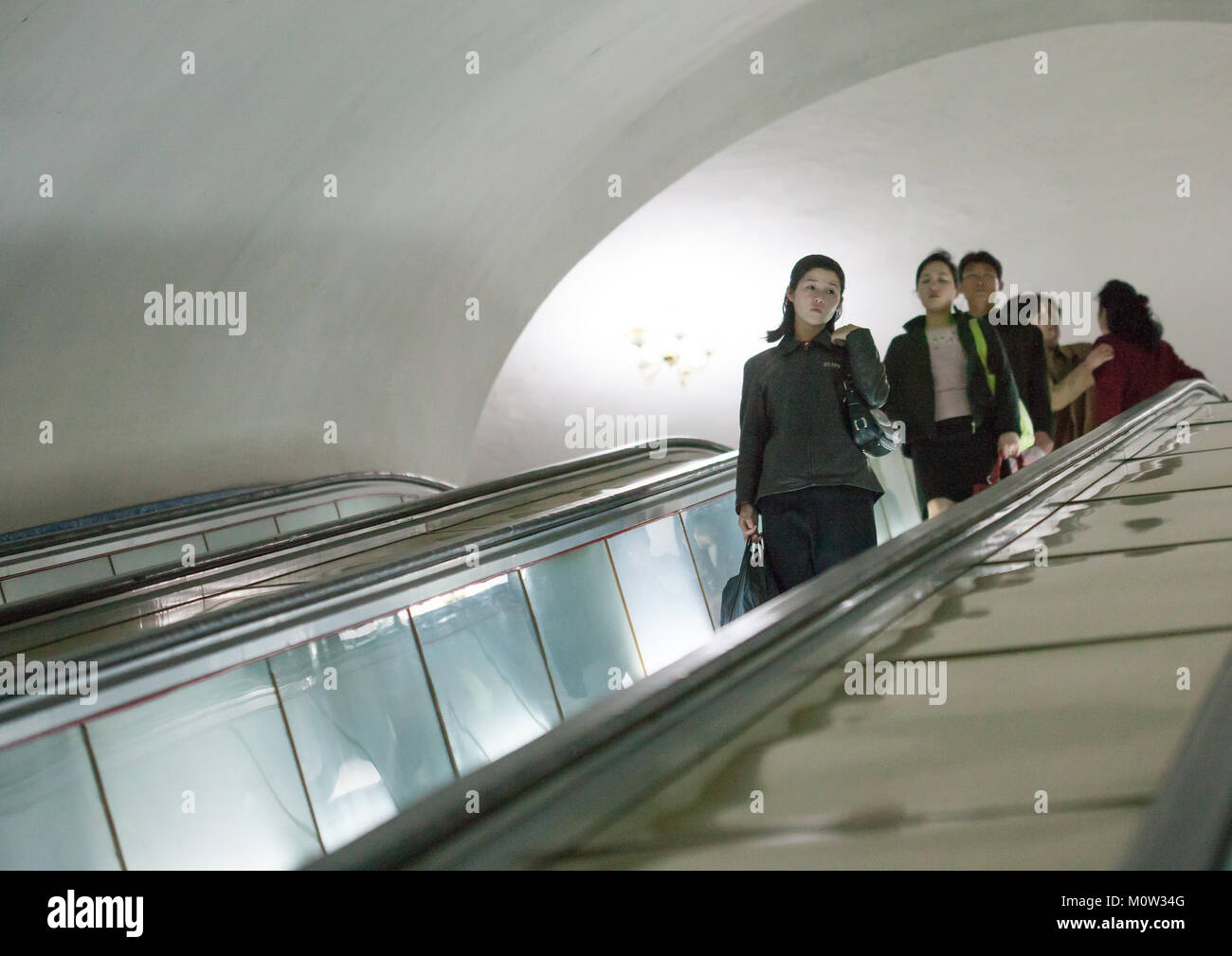 North Korean people using escalator leading to the subway station ...