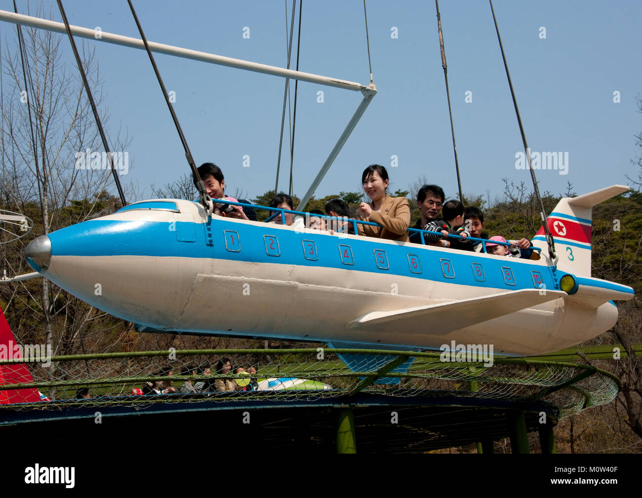 North Korean people having fun on a plane attraction in Taesongsan ...