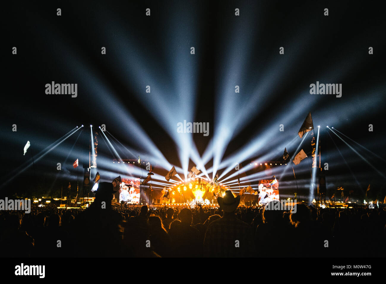 The area in front of the Orange Stage is packed with festival goers and ...