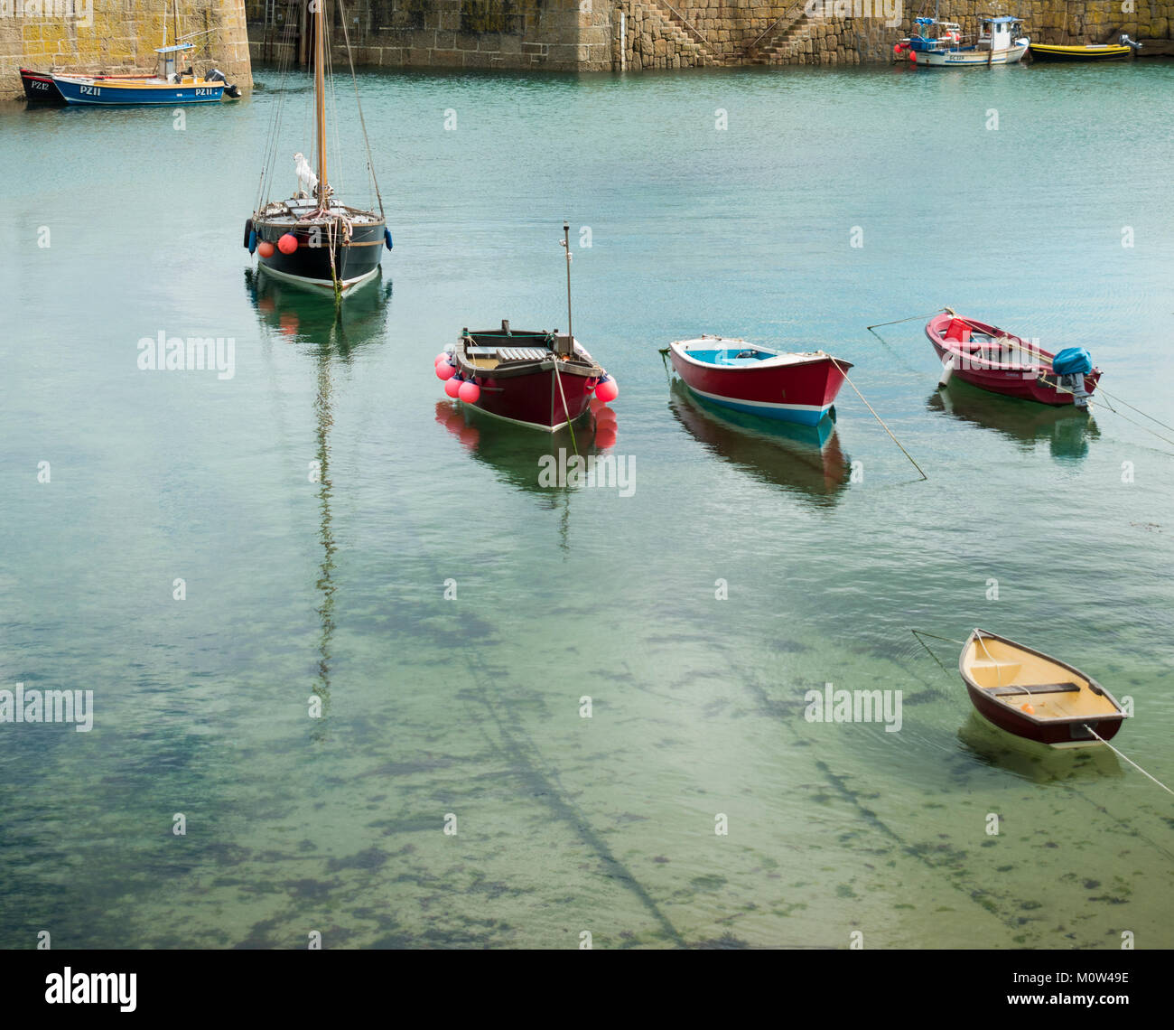 Boats in the harbour of the pretty fishing village of Mousehole in ...