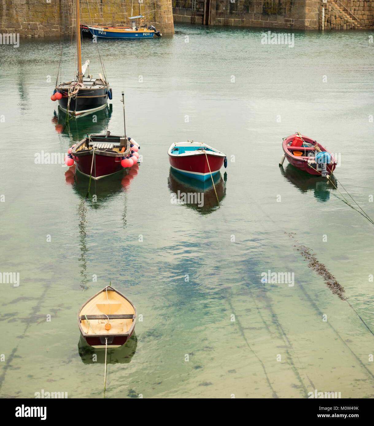 Boats in the harbour of the pretty fishing village of Mousehole in ...