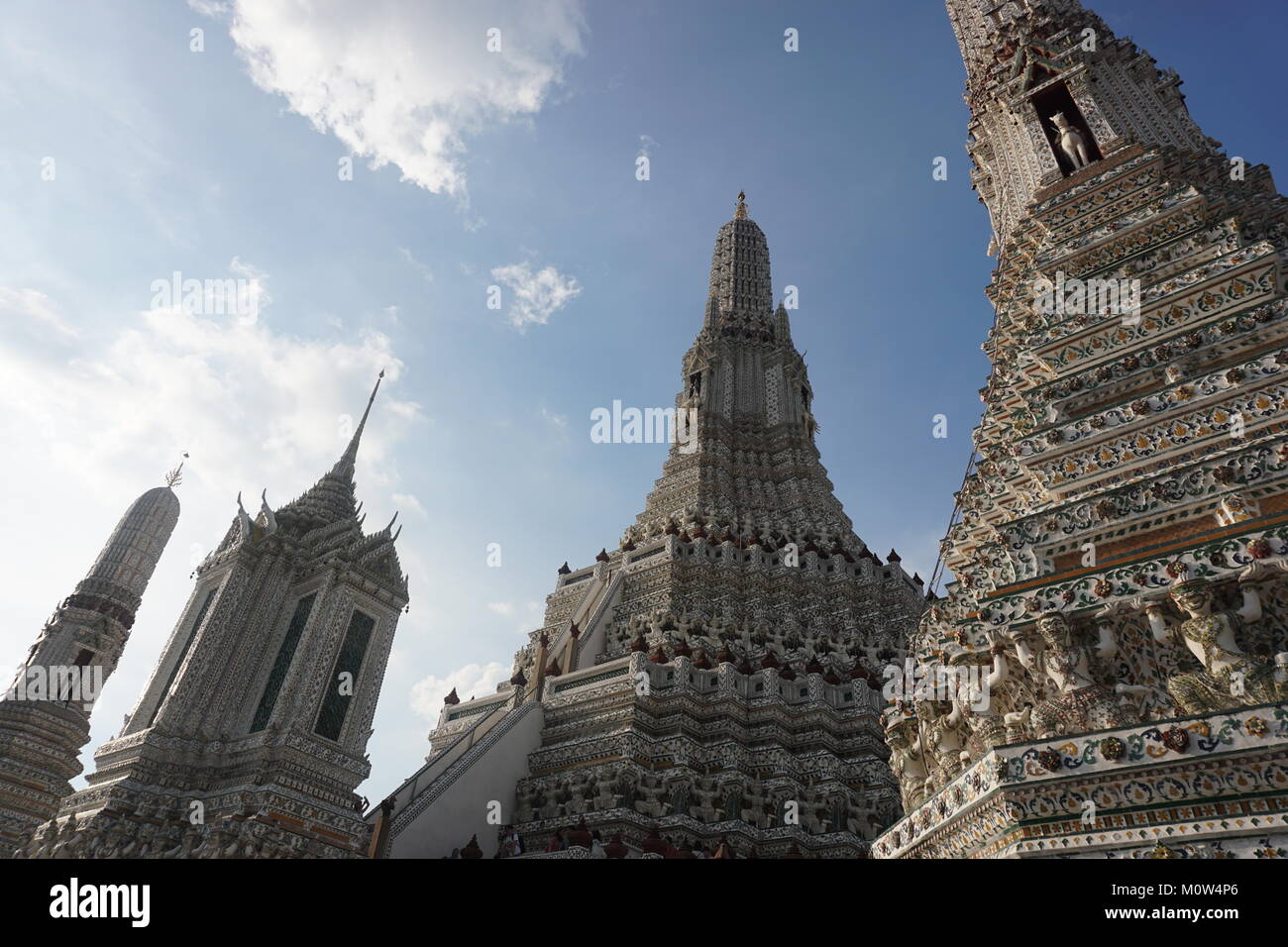 The temple of Wat Arun and its' colorful and detailed structures with a ...