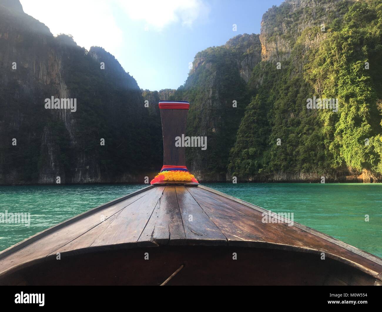 View out of a long tail boat (in sharp focus) into the beautiful ...
