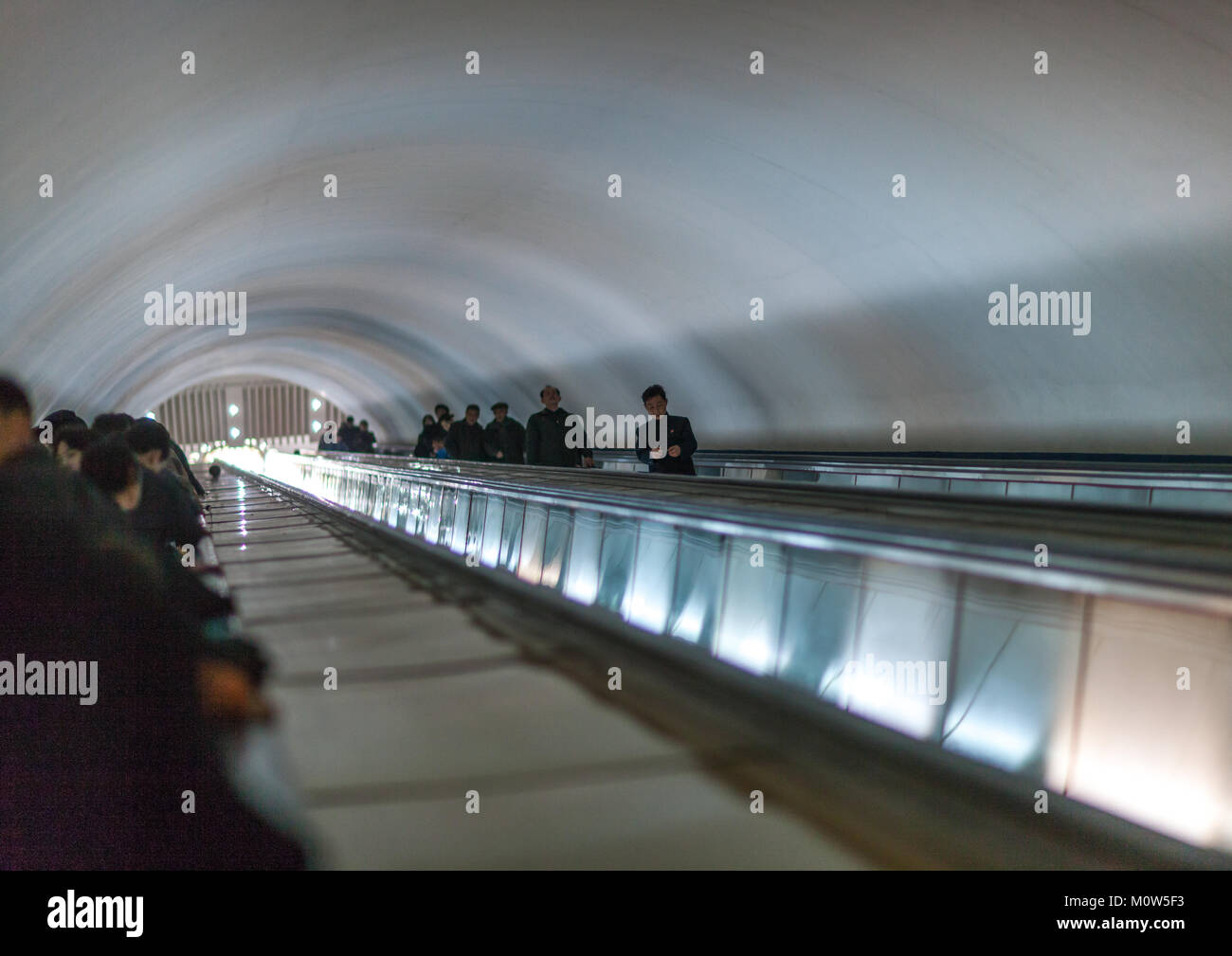 North Korean people using escalator leading to the subway station ...