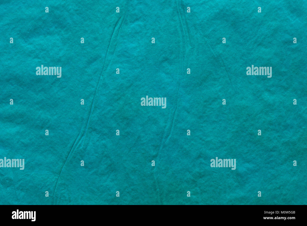 turquoise color creased tissue paper bacground texture Stock Photo - Alamy