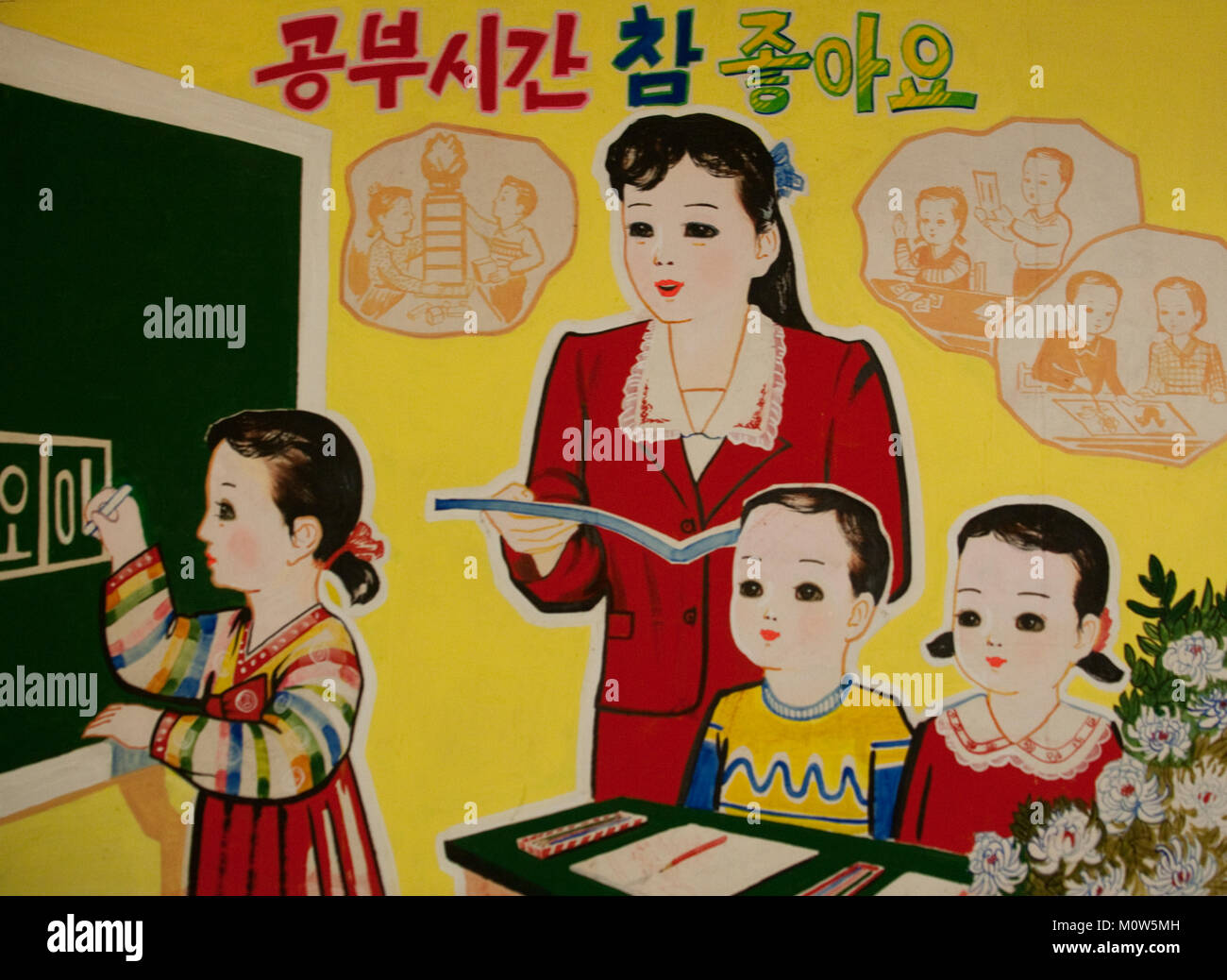 Propaganda poster in a school depicting a teatcher with pupils, Pyongan ...