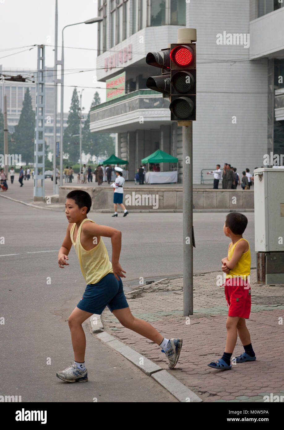 North Korean boys crossing a street under a traffic light, Pyongan ...
