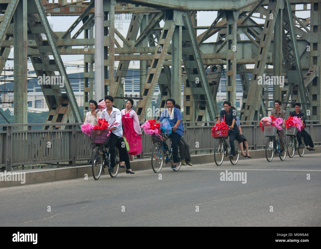 Group of North Korean women cycling across a bridge, Pyongan Province ...