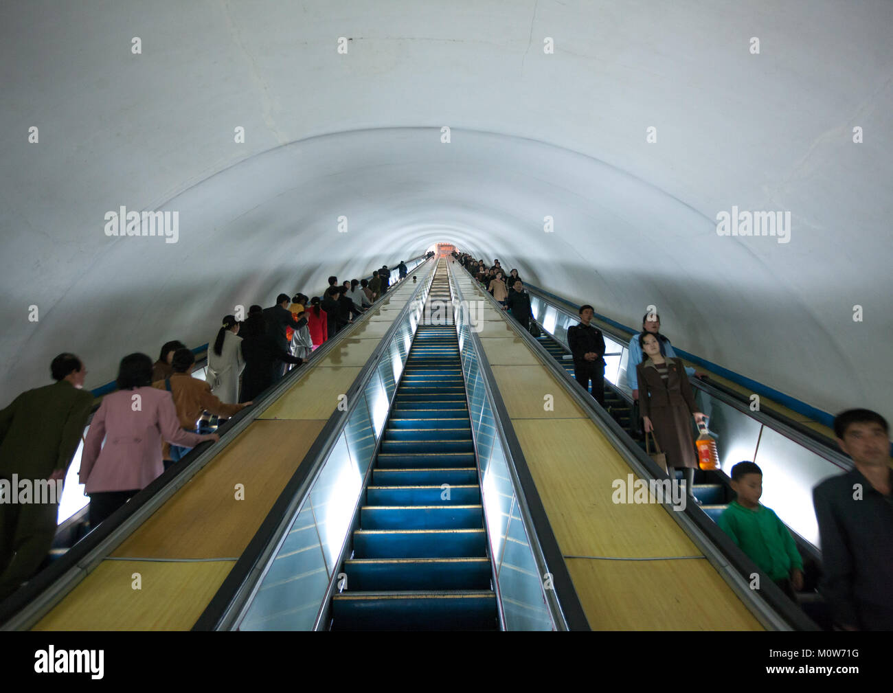 North Korean people using escalator leading to the subway station ...
