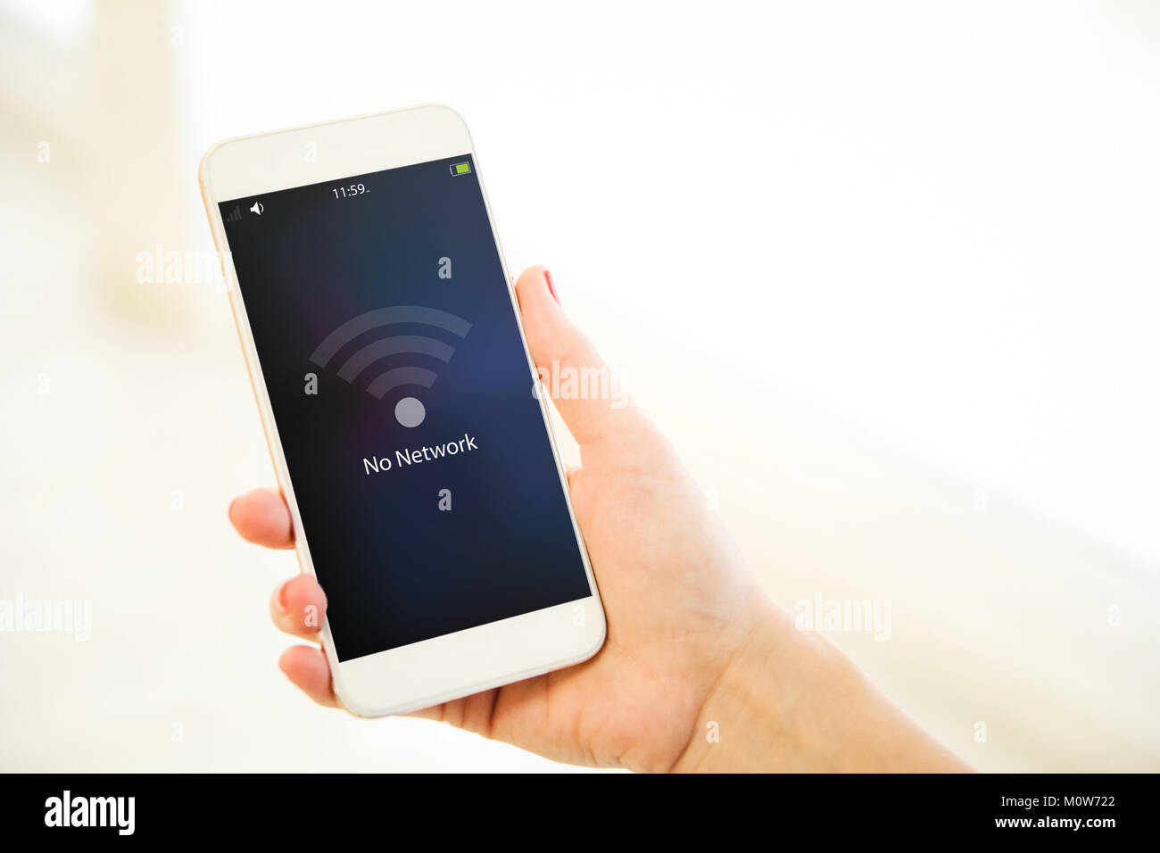 Woman holding a pink gold generic smartphone showing no network Stock ...