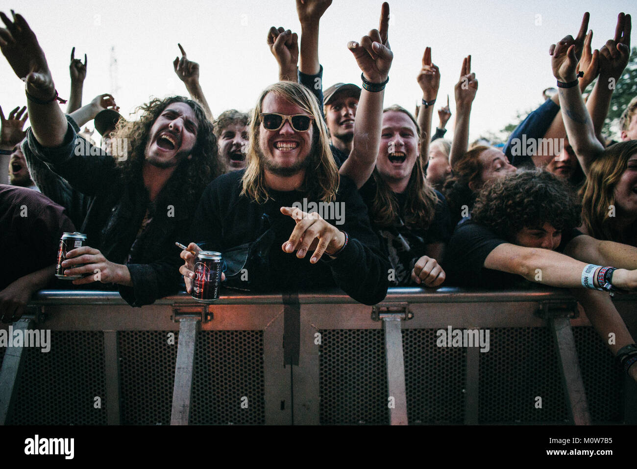 Enthusiastic and energetic music fans go crazy at a concert with the ...