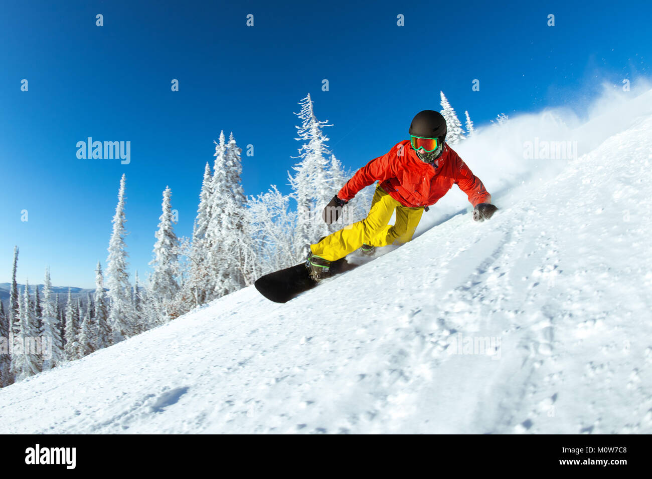 Very fast snowboarder slides at ski slope Stock Photo - Alamy