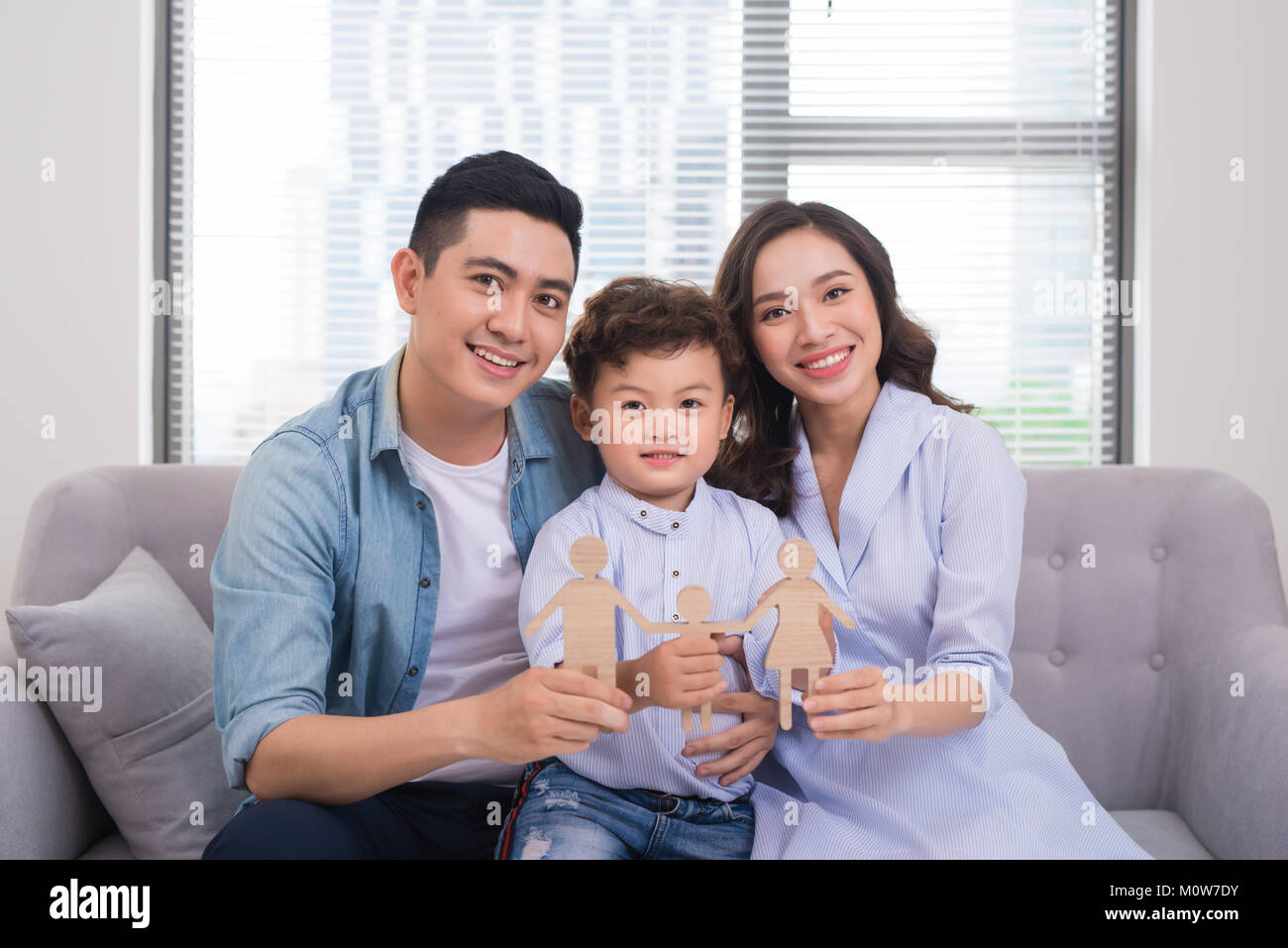 Smiling young parents and their child are very happy Stock Photo - Alamy