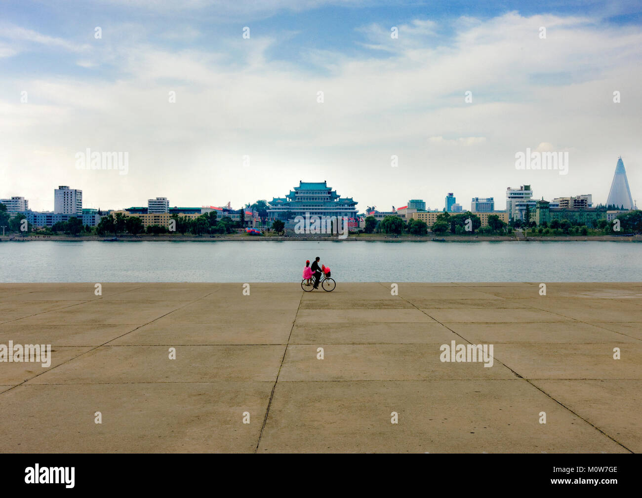 North Korean coupe riding a bicycle in front of Taedong river, Pyongan ...