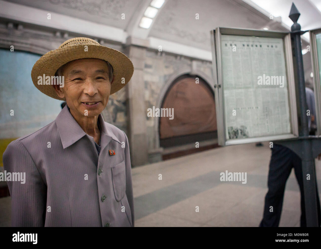 North Korean man reading the offical state newspaper in a metro station ...