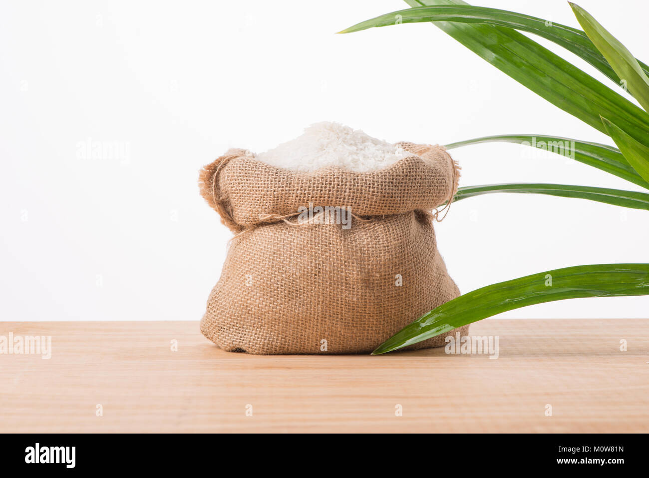 Jasmine white rice in sack isolated on white background Stock Photo - Alamy