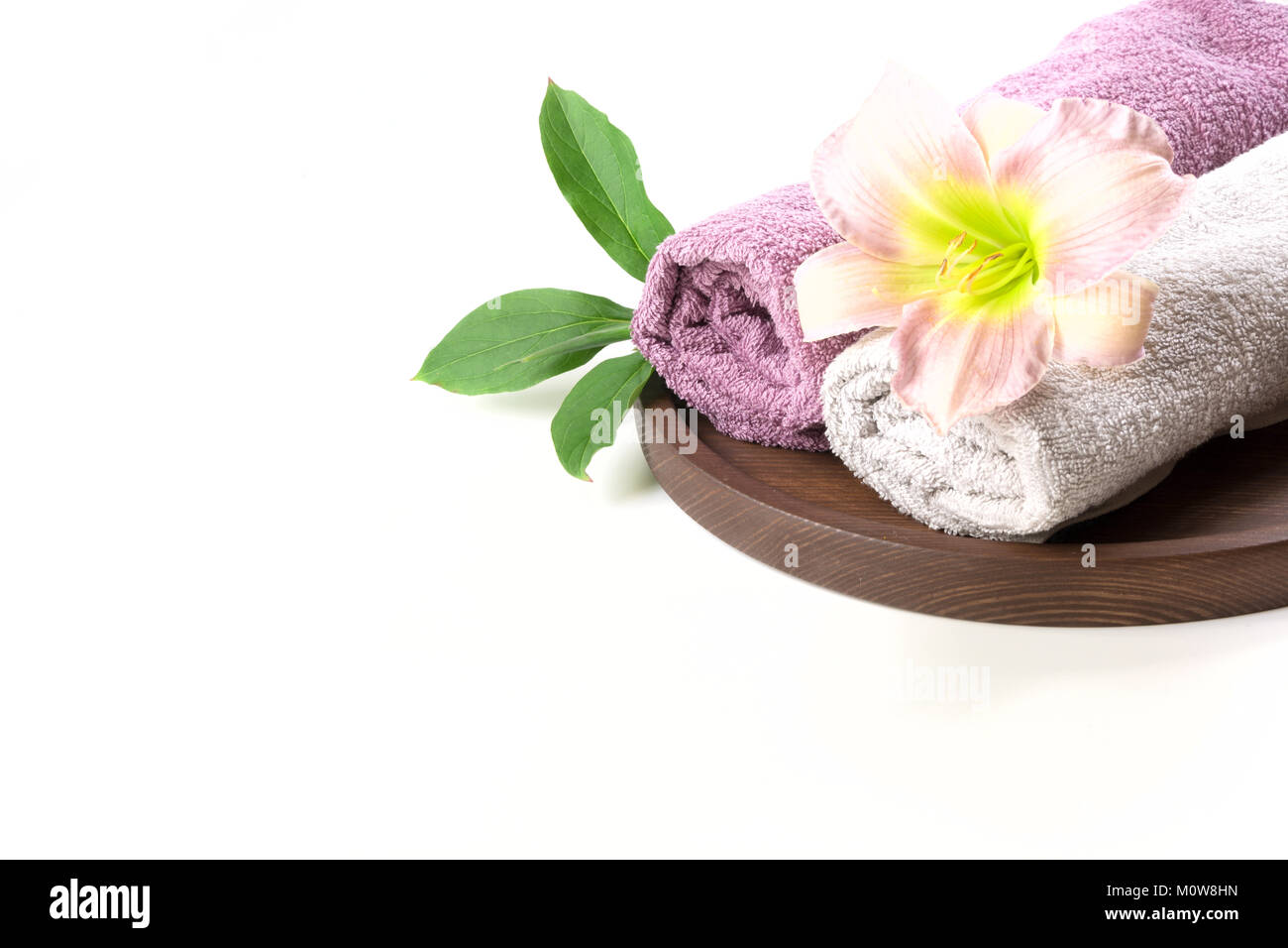 Spa setting of towel, flower isolated on white background with copy ...
