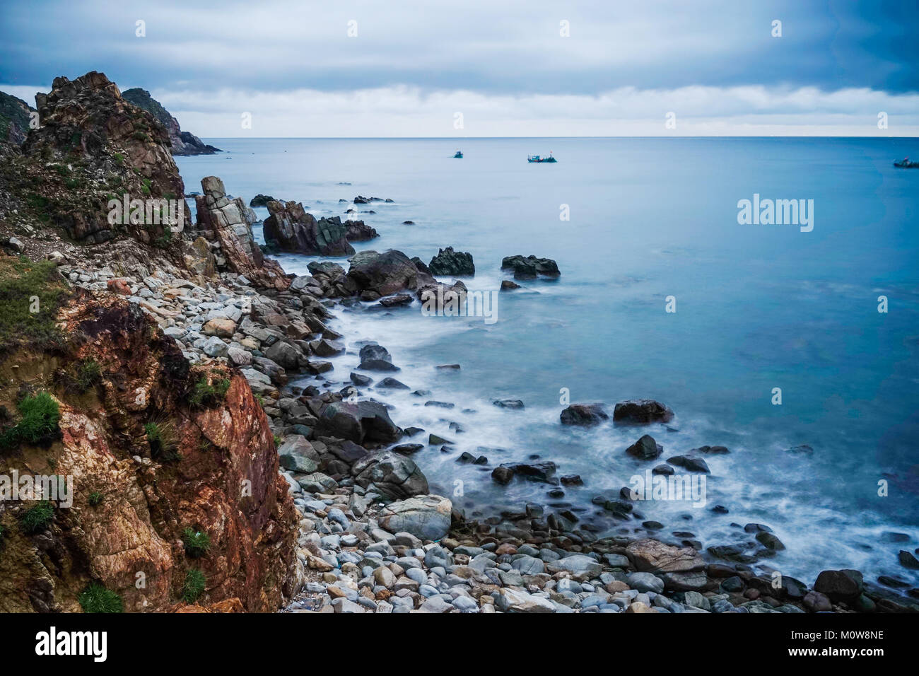 Rocks on blue ocean at beautiful sunset in summer time Stock Photo - Alamy