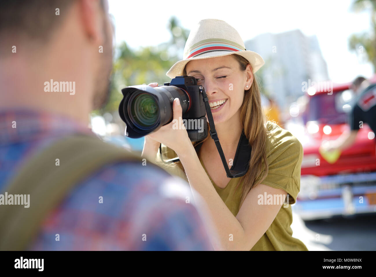 Woman photographer taking picture of model in the street of Miami Stock ...