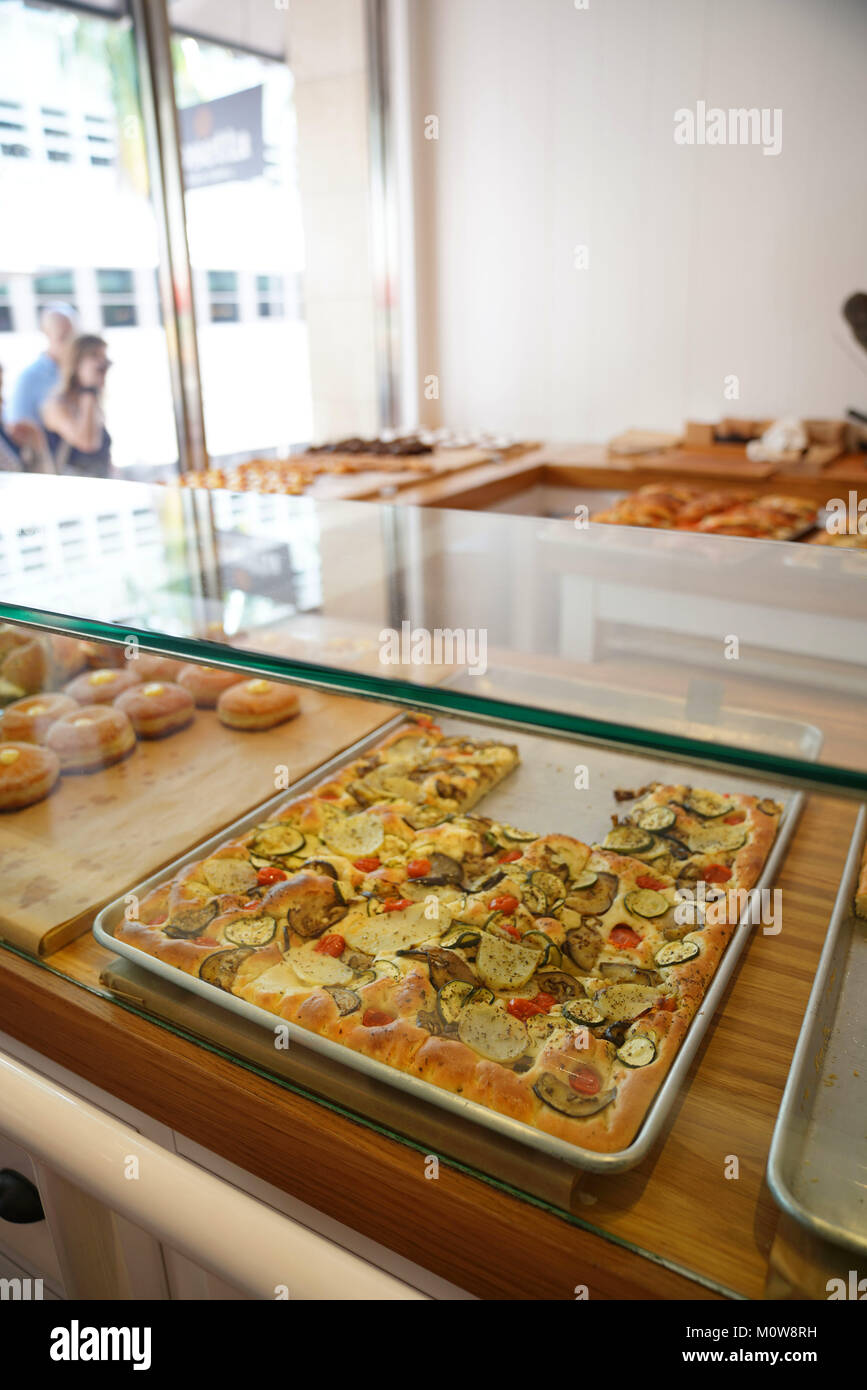 Pizza pan in bakery shop stand Stock Photo - Alamy