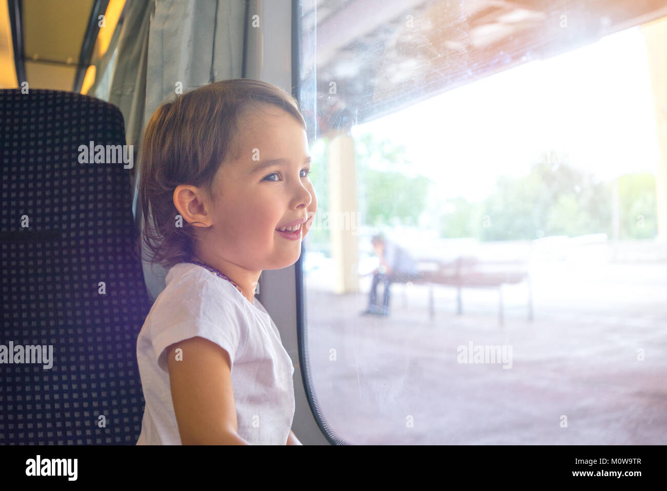 Happy little girl traveling by train Stock Photo - Alamy