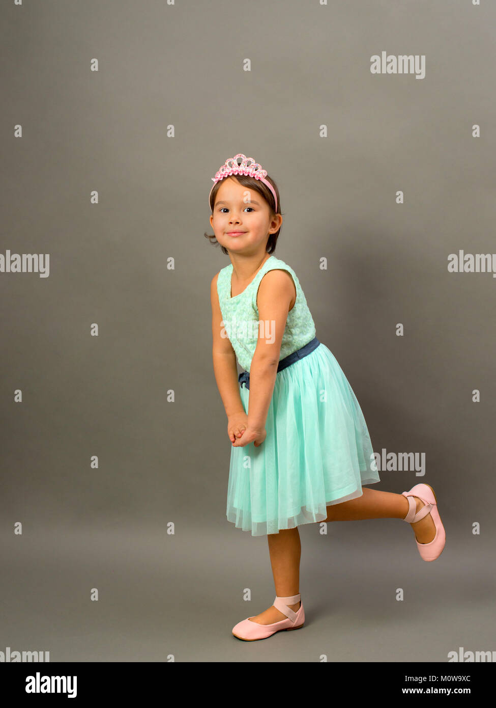 Full length of little fashion girl in studio Stock Photo - Alamy