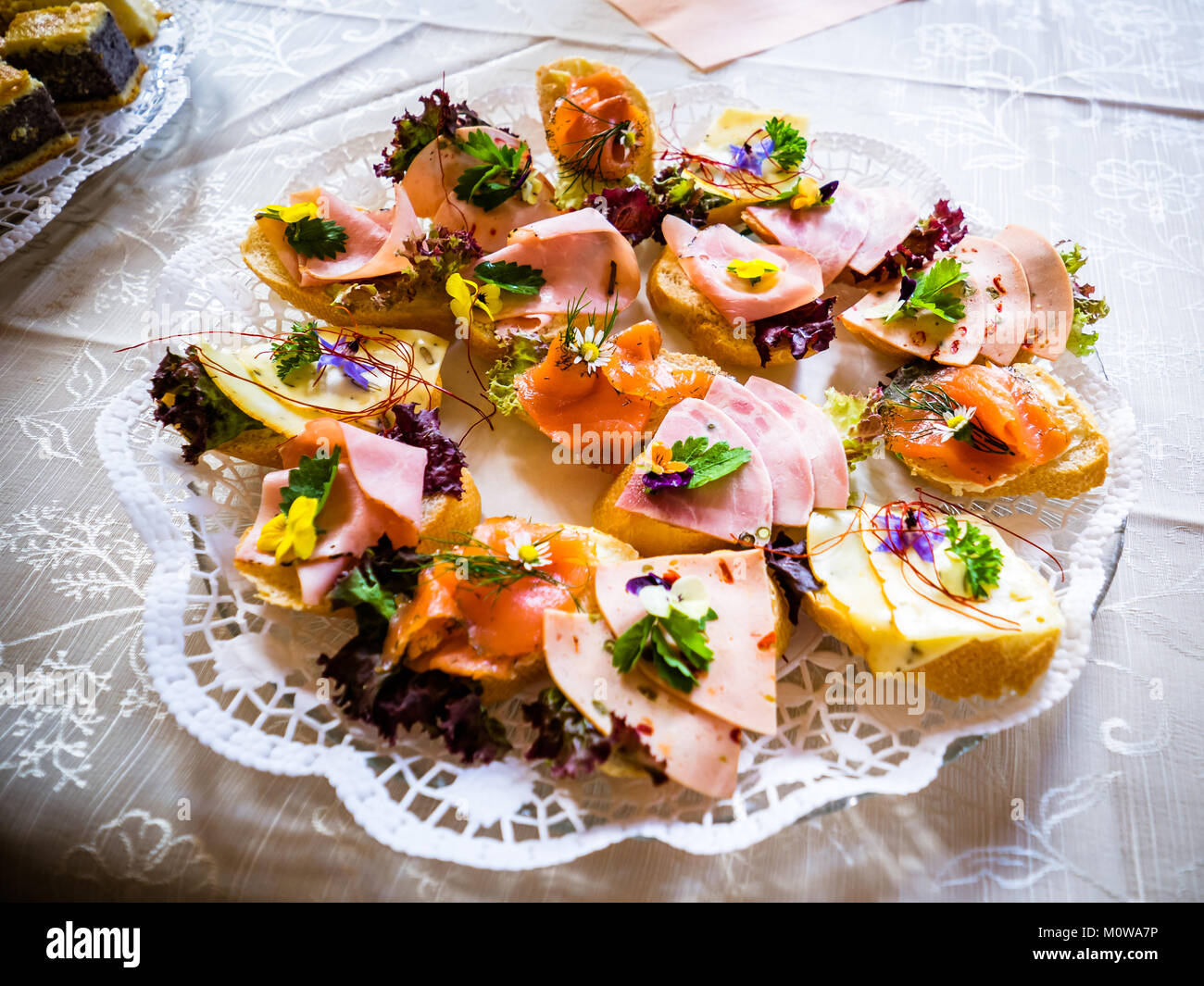the snacks on the plate with ham, egg and petals Stock Photo - Alamy