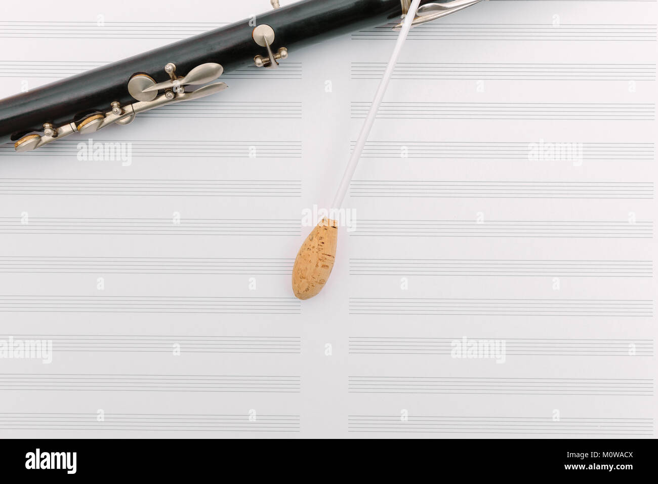 transverse flute and baton on sheet music Stock Photo - Alamy