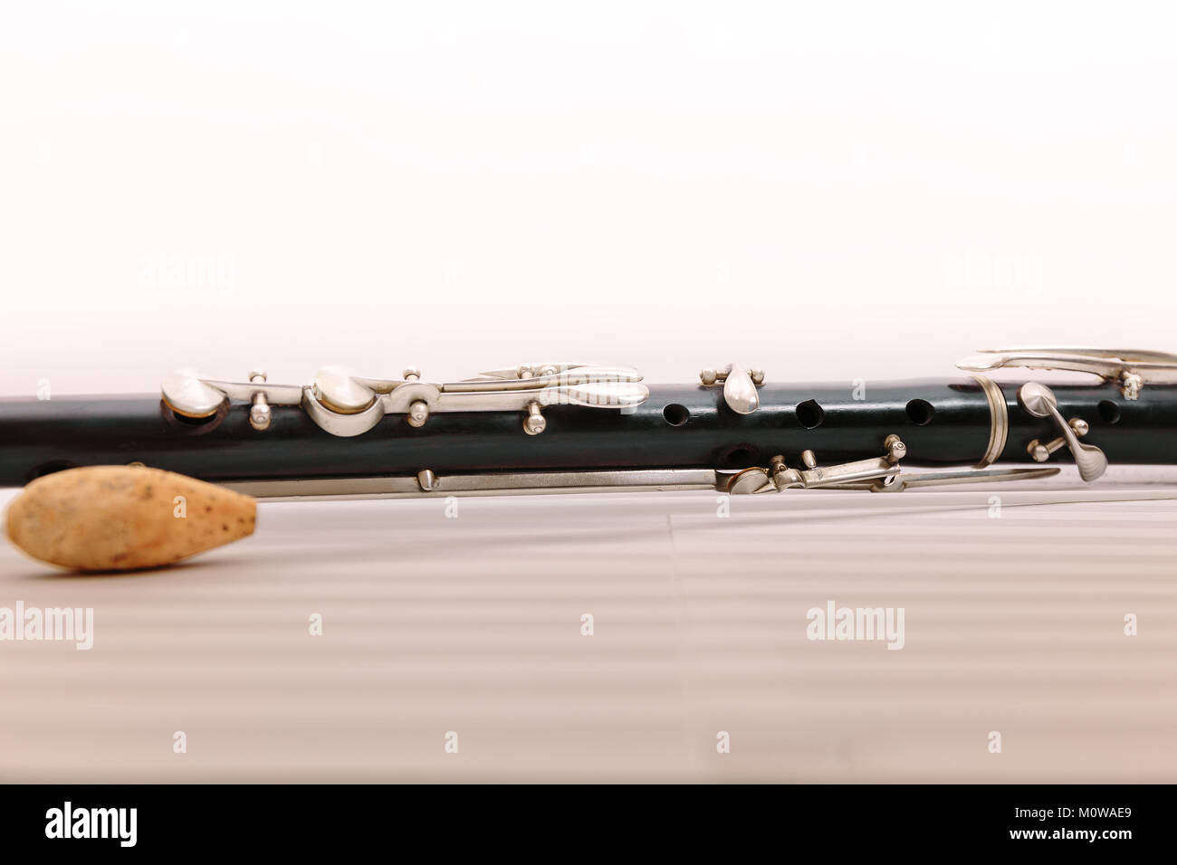 transverse flute and baton on sheet music Stock Photo - Alamy