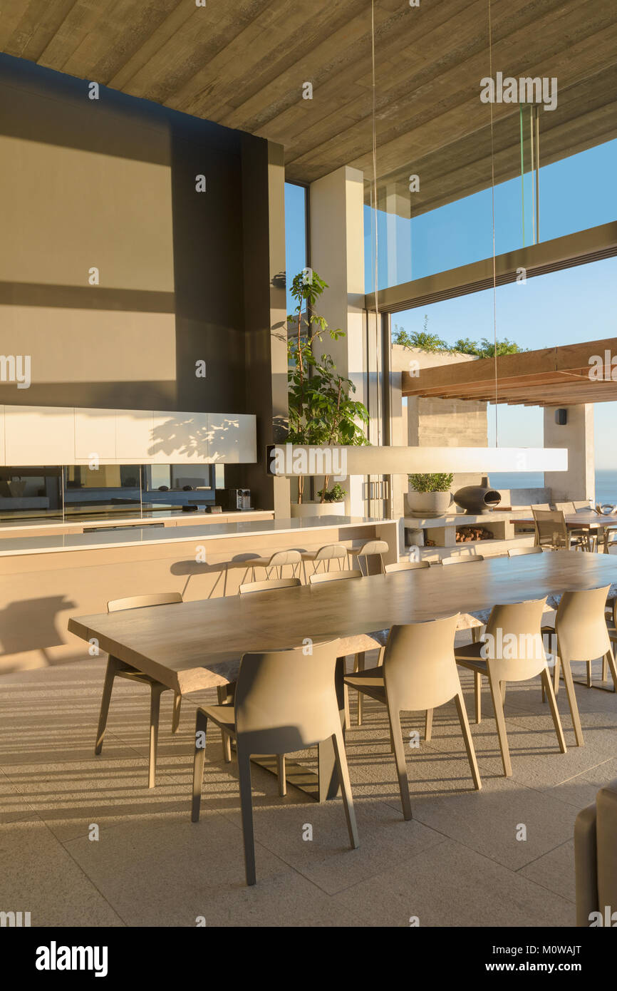 Sunny modern, luxury home showcase interior dining room Stock Photo - Alamy