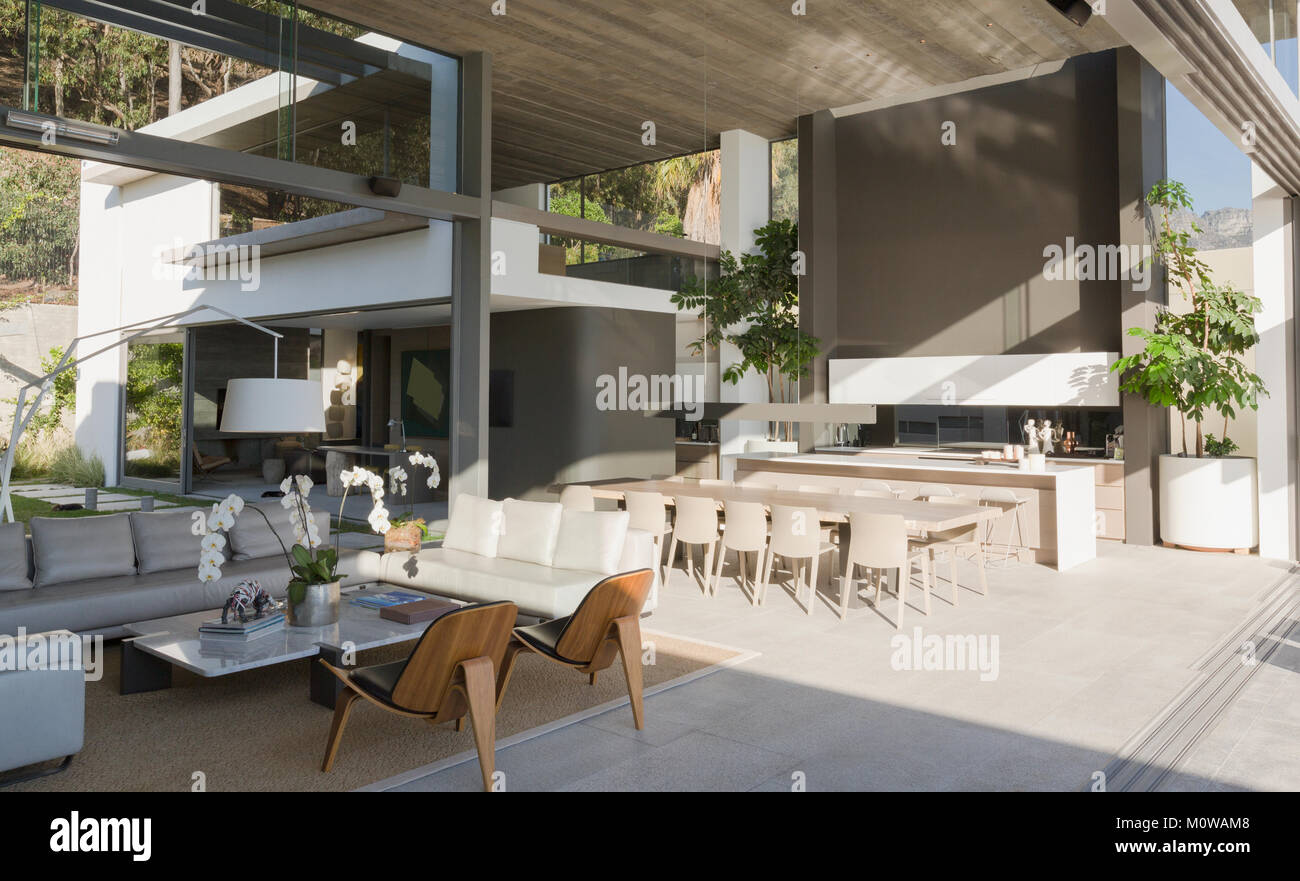 Sunny modern, luxury home showcase interior living room and dining room ...