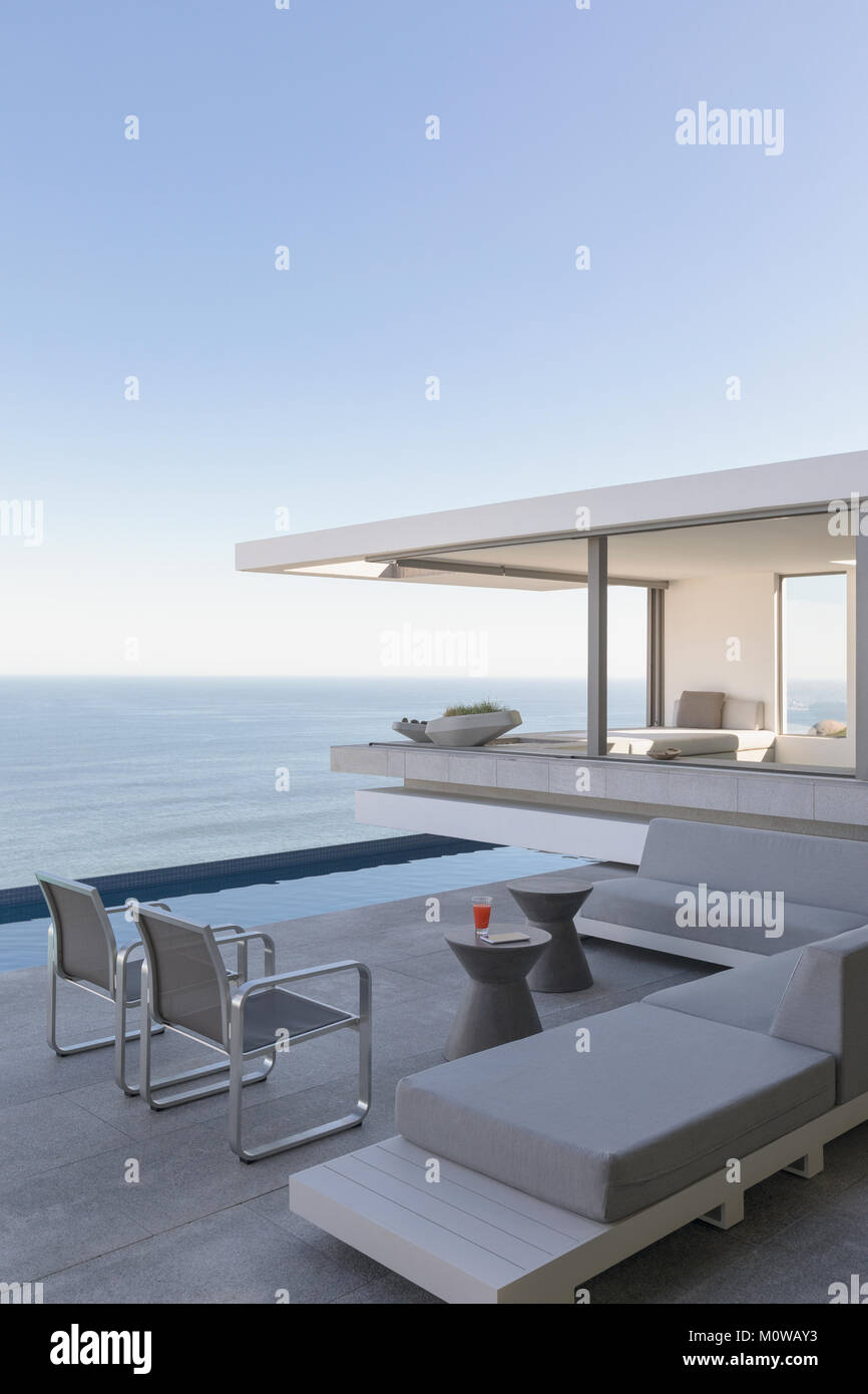 Modern, luxury home showcase exterior patio with ocean view Stock Photo ...