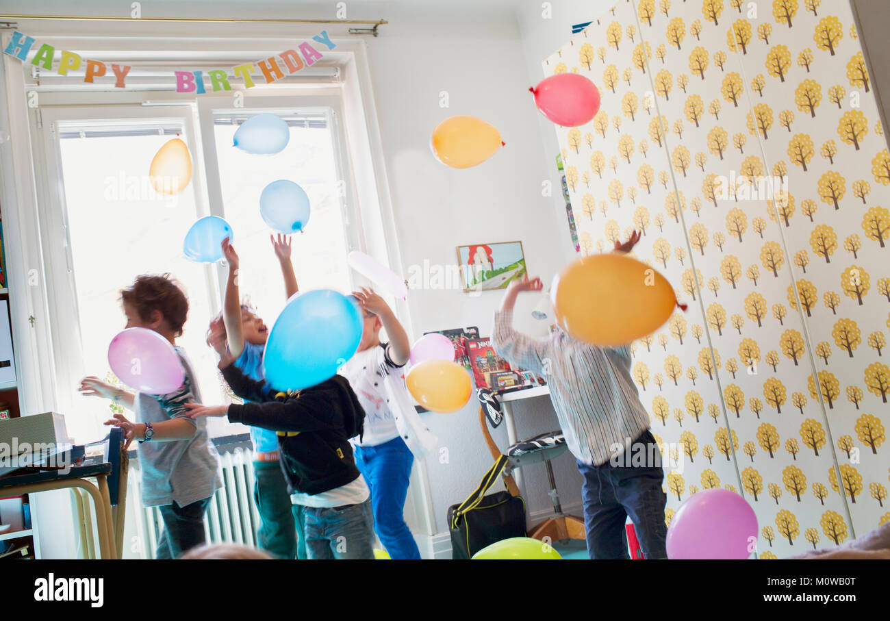 Children playing with balloons hi-res stock photography and images - Alamy