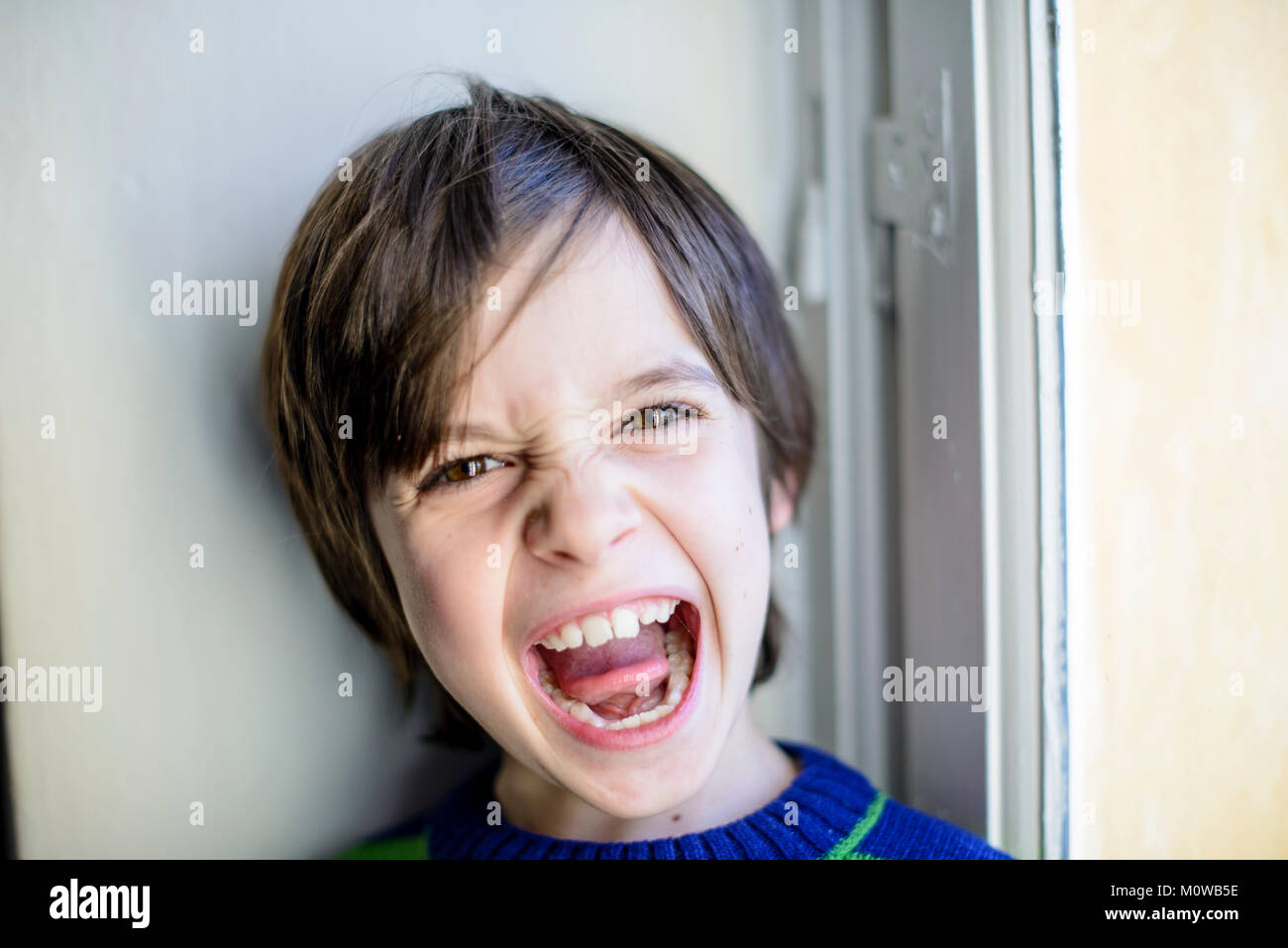 child makes grimaces Stock Photo - Alamy