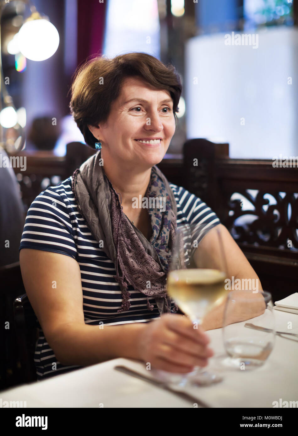 Elderly lonely woman at dinner in restaurant Stock Photo - Alamy