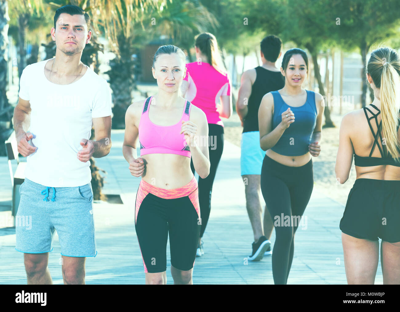 Active smiling people during running training in daytime Stock Photo ...