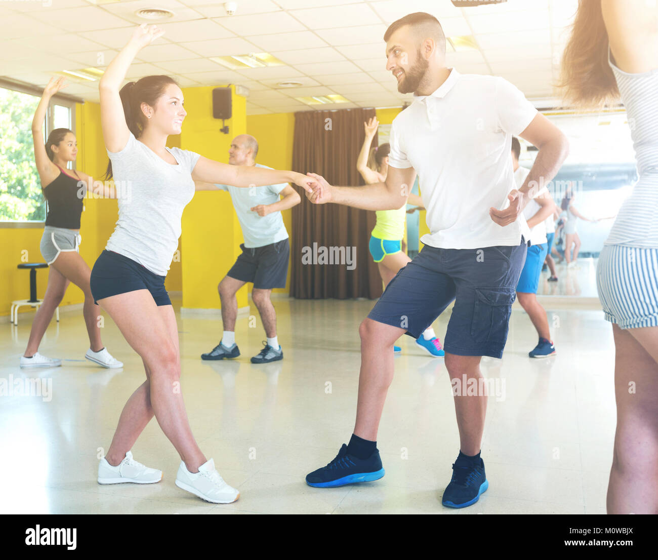 Young happy people dancing lindy hop in pairs in dance hall Stock Photo ...