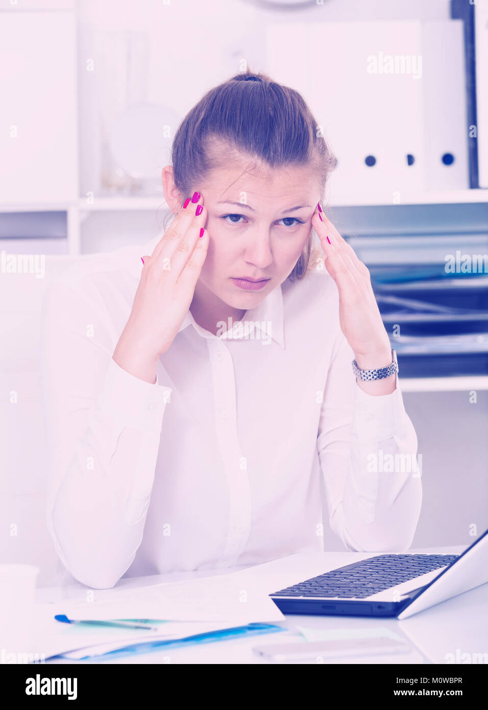 Female office worker is having complicated issue with project in office ...