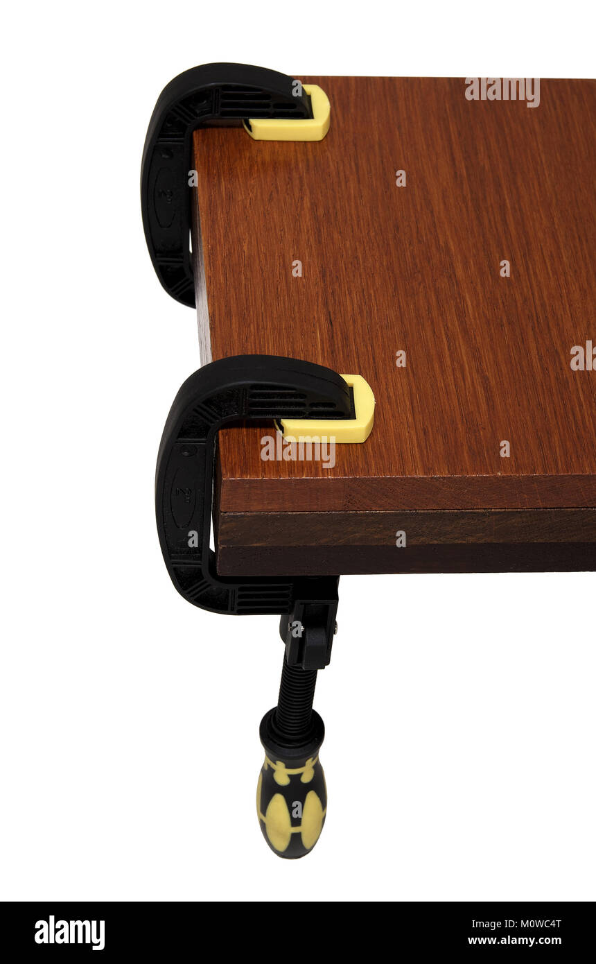 clamps of yellow color hold three wooden bars on a white background ...