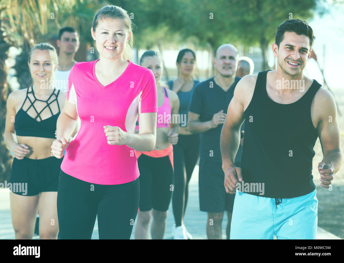 Active smiling people during running training in daytime Stock Photo ...