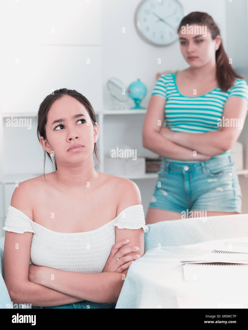 Two offended teens girls not talking to each other after quarrel at ...