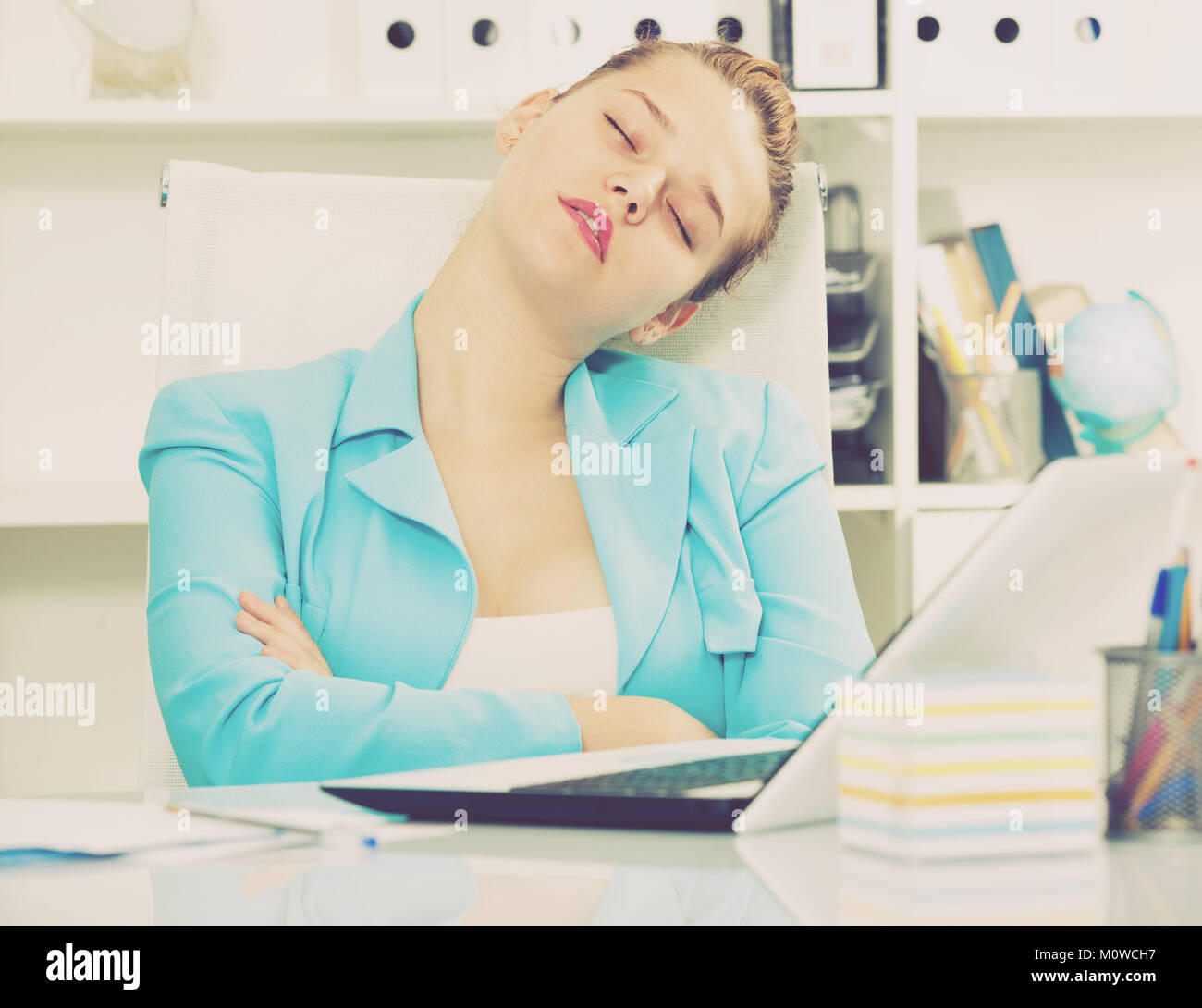 Female employee is sleeping after productive day at work in office ...