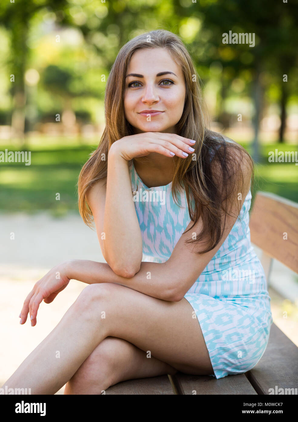 portrait of positive smiling young greek female portrait in garden ...