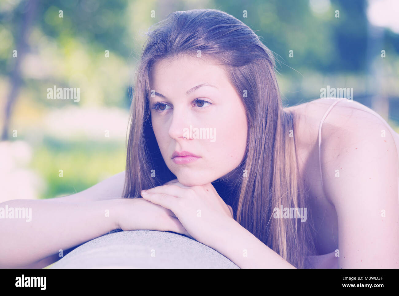Young woman is feeling distressed and lonely alone at the park Stock ...