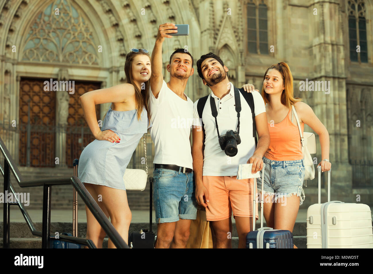 Four ordinary travellers making selfie with mobile phone Stock Photo ...