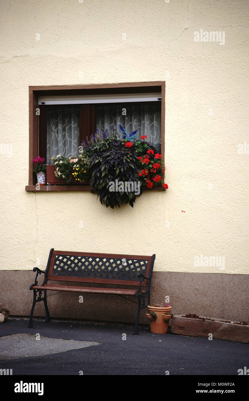 A window decorated with flowers and plants on a residential house Stock ...