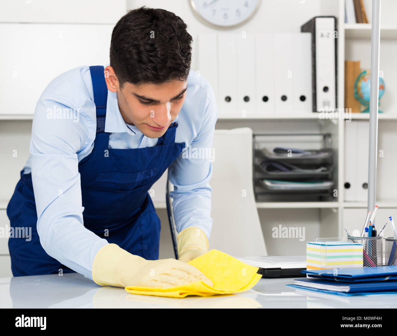 Person is cleaning dust from the desk in the office Stock Photo - Alamy